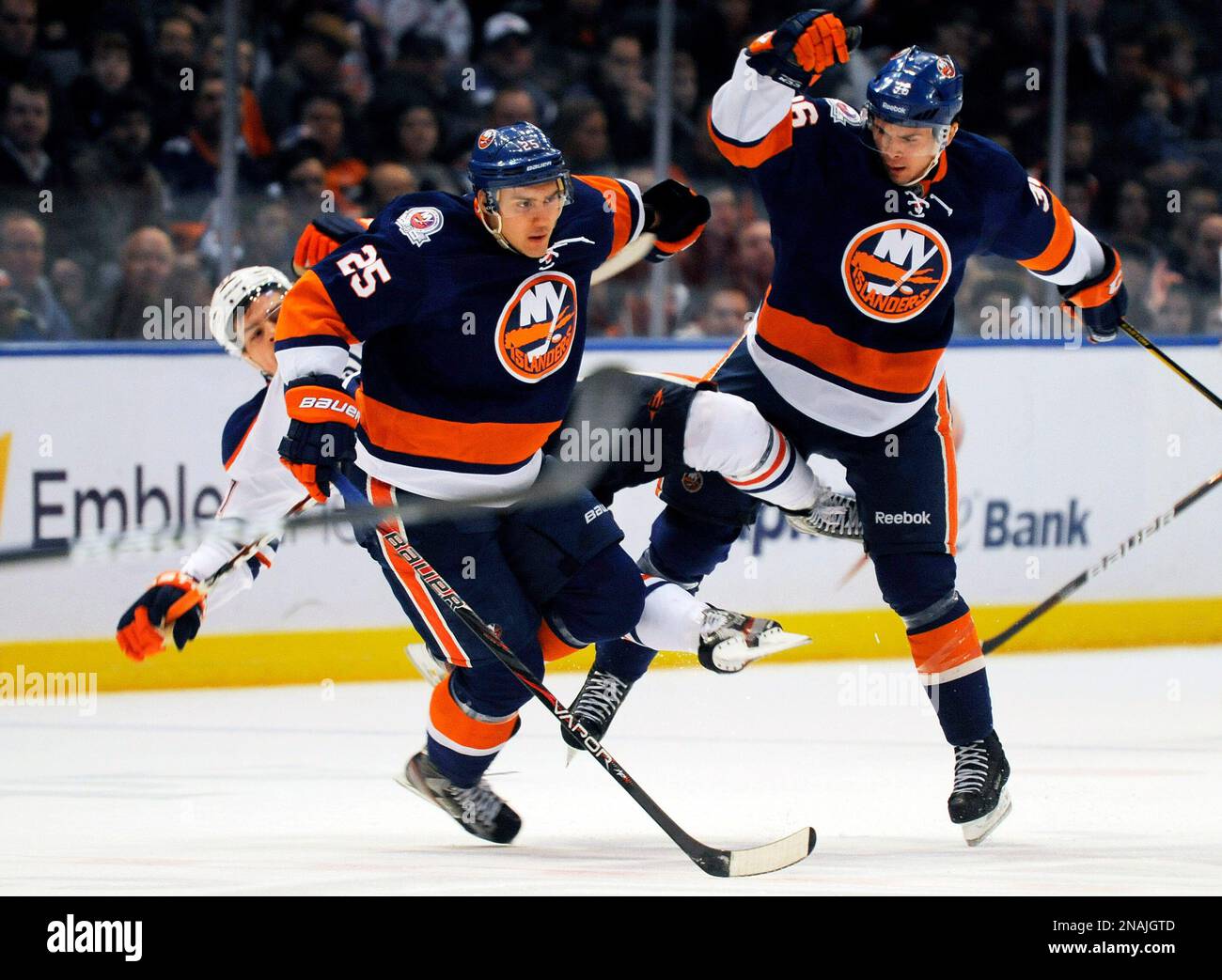 New York Islanders Tim Wallace, right, and Nino Niederreiter, center ...