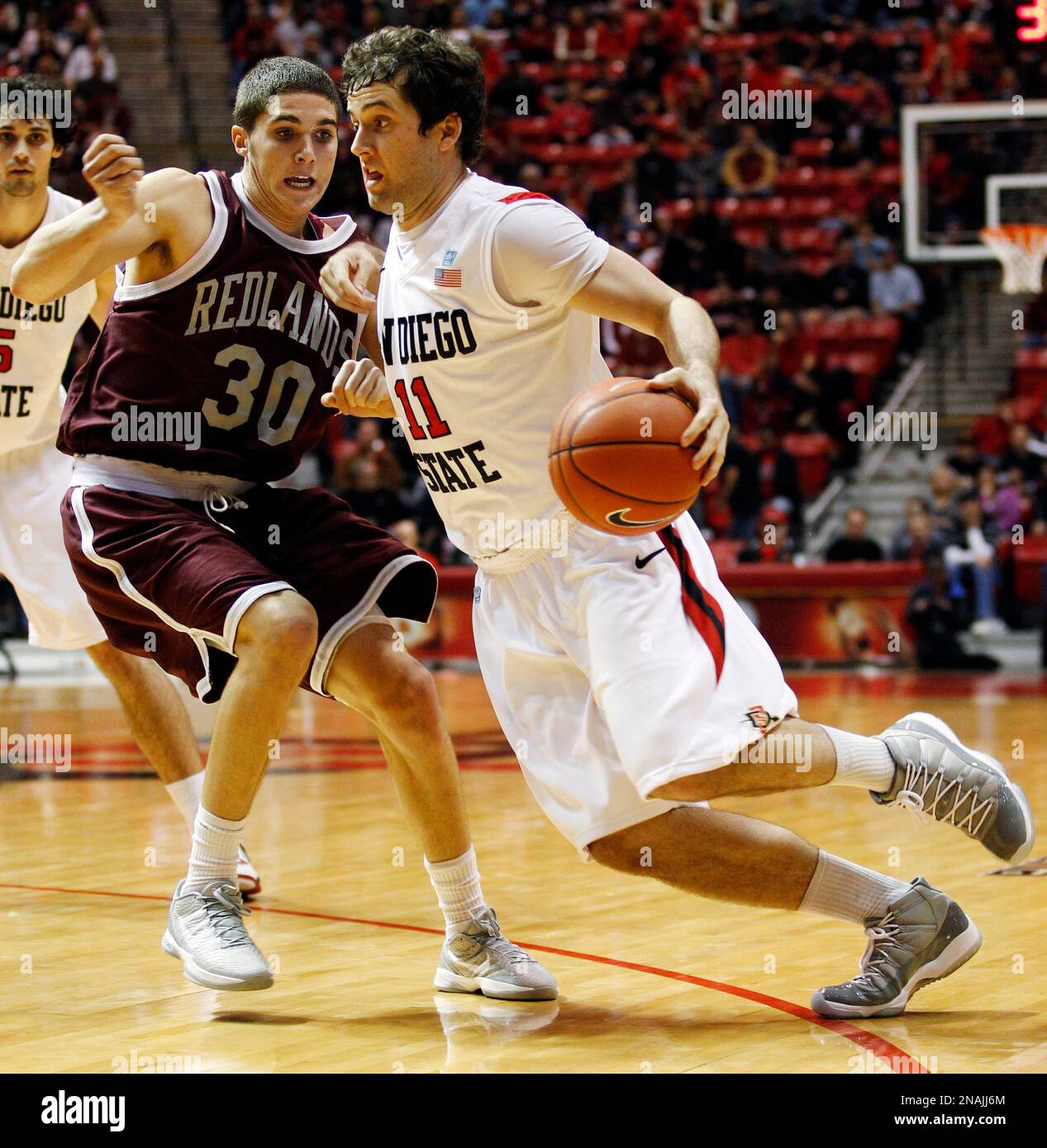 San Diego State's James Rahon drives past Redlands' Matt Calhoun during ...