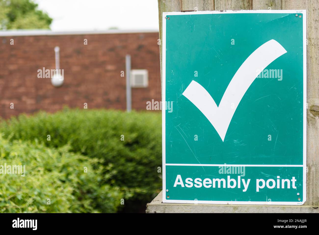 A fire assembly point sign indicates the rendezvous point in case of ...