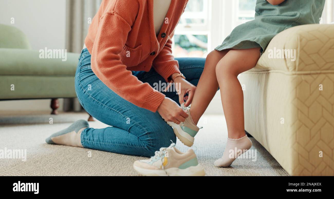 Mother, child and shoes in preparation for school, learning or ...