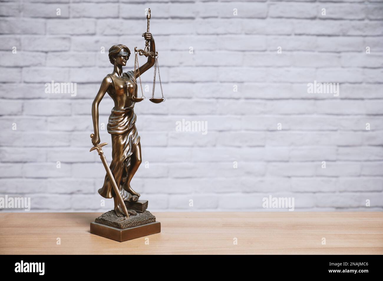 Lady Justice or Justitia the goddess of justice statue on desk - legal ...