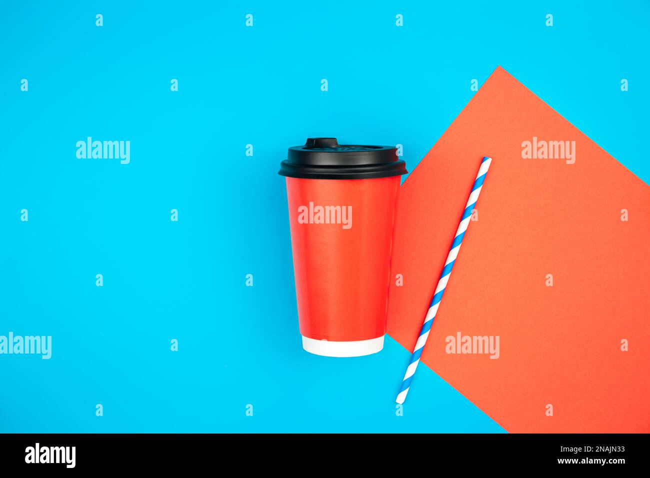 Paper cup and paper straw for drinks on a blue background, flat lay ...