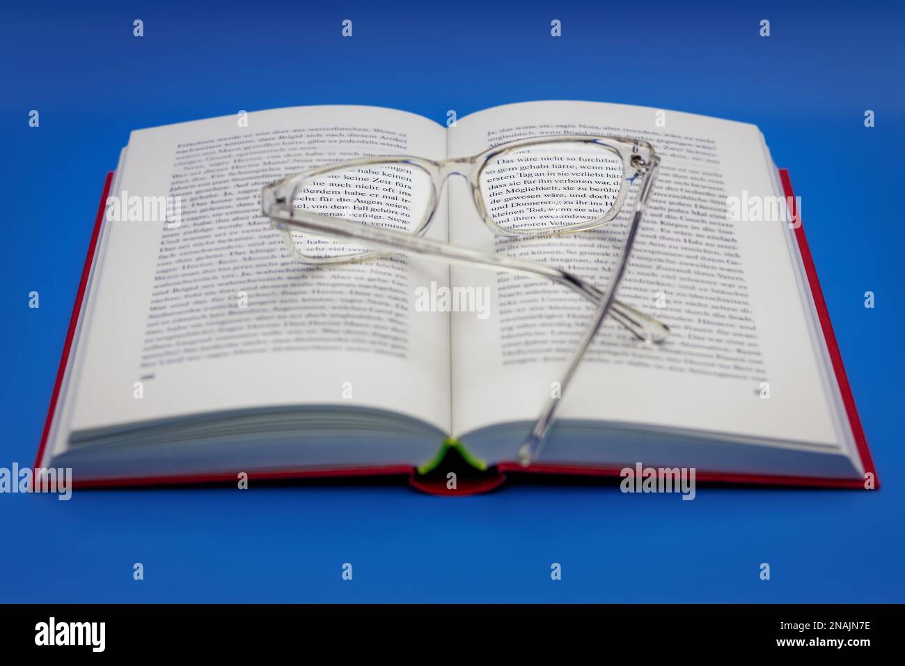 reading glasses on an open book Stock Photo - Alamy