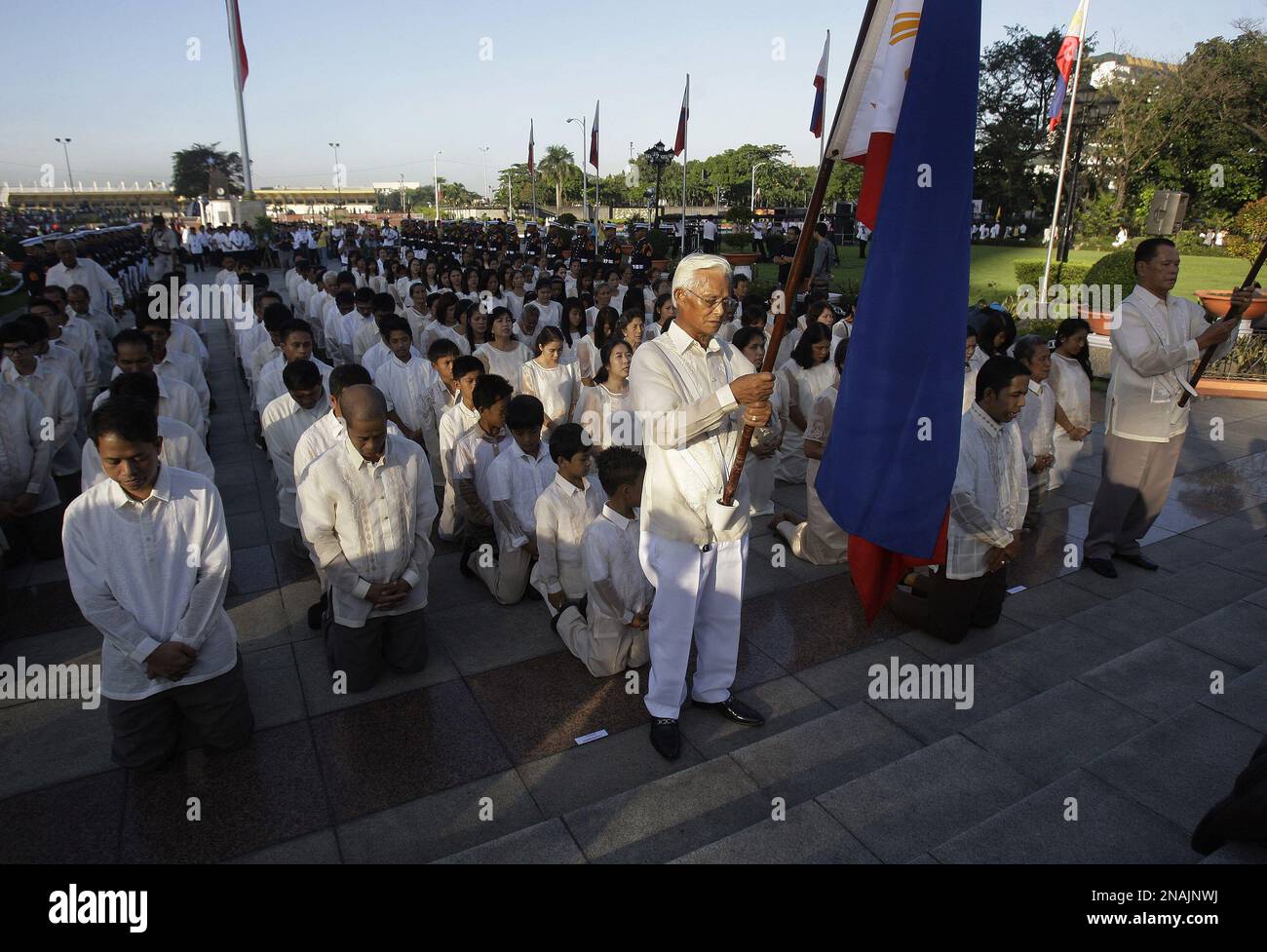 Followers of Philippine National Hero Jose Rizal kneel in front of his ...