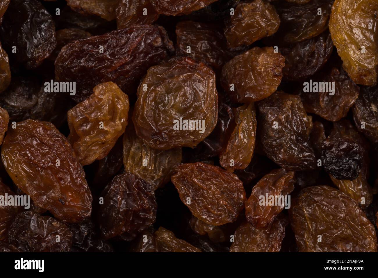 Sweet dry raisins close up shot for background Stock Photo - Alamy