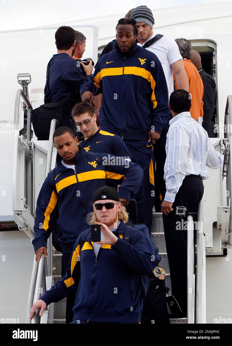 West Virginia offensive lineman Pat Eger, front, takes photographs as ...