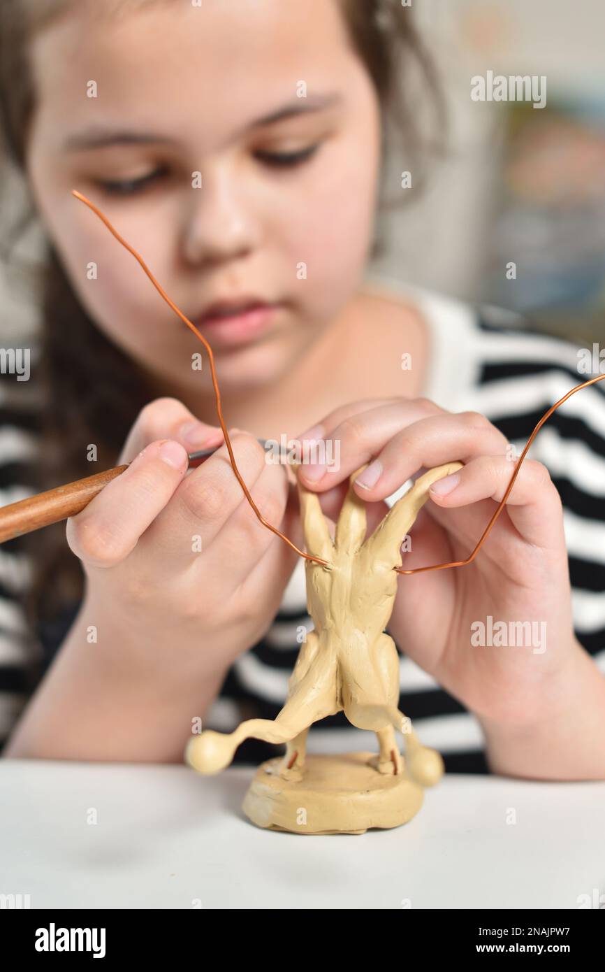 Teenager sculpt figures from plasticine, children's creativity concept ...