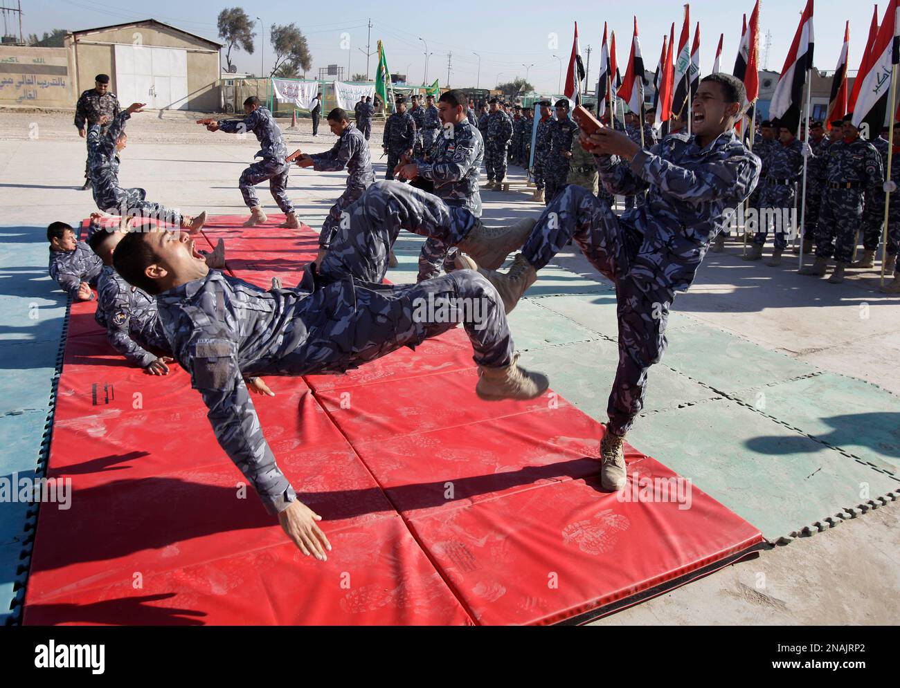 Iraqi national police graduates demonstrate their skills during a ...