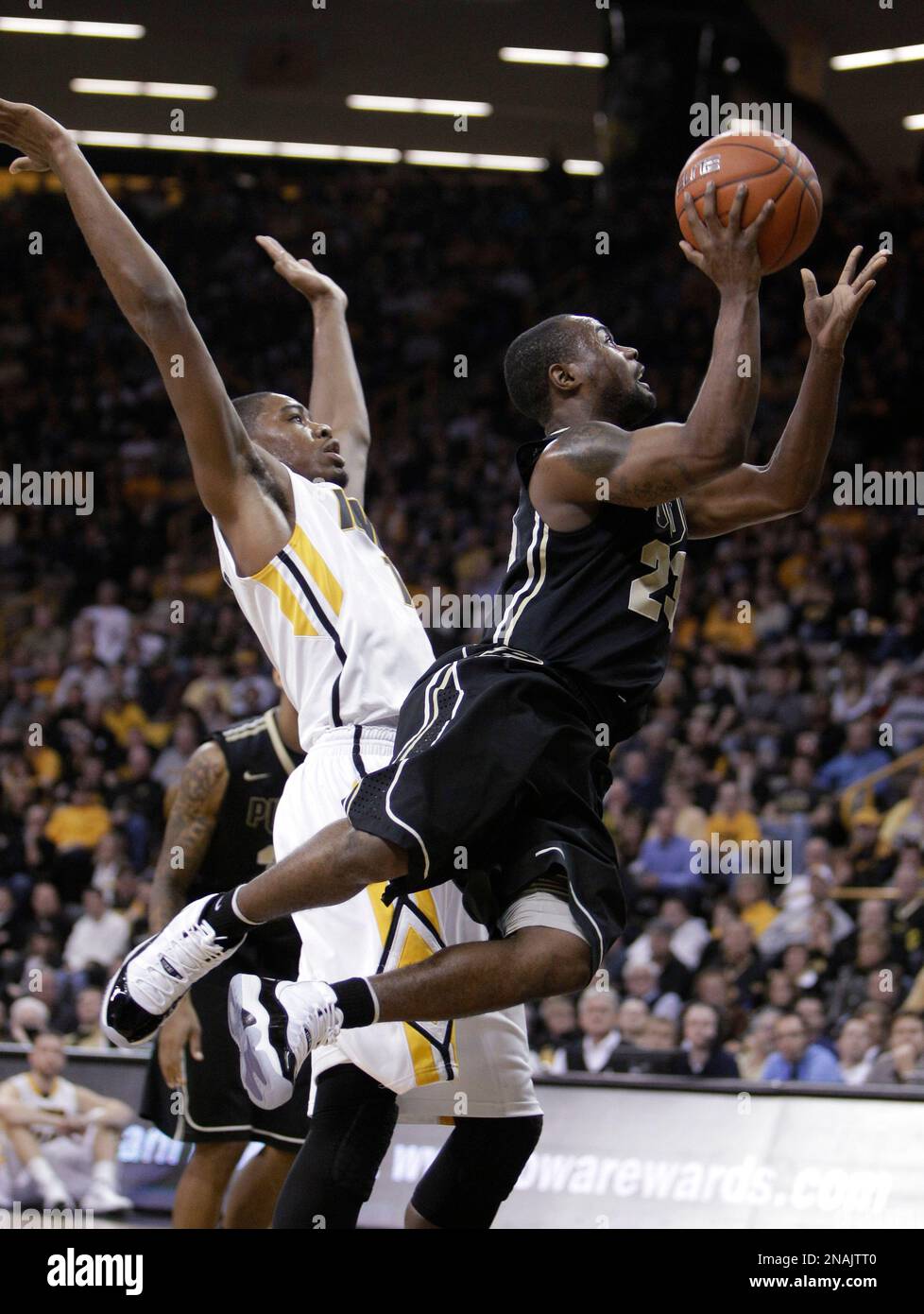 Purdue guard Lewis Jackson drives to the basket past Iowa forward ...