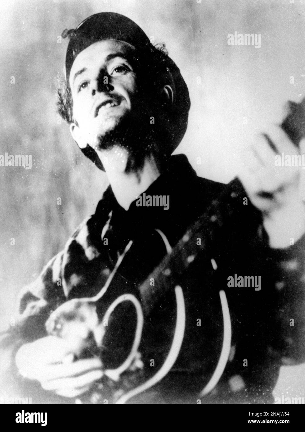 FILE - This undated file photo shows folk singer Woody Guthrie playing ...