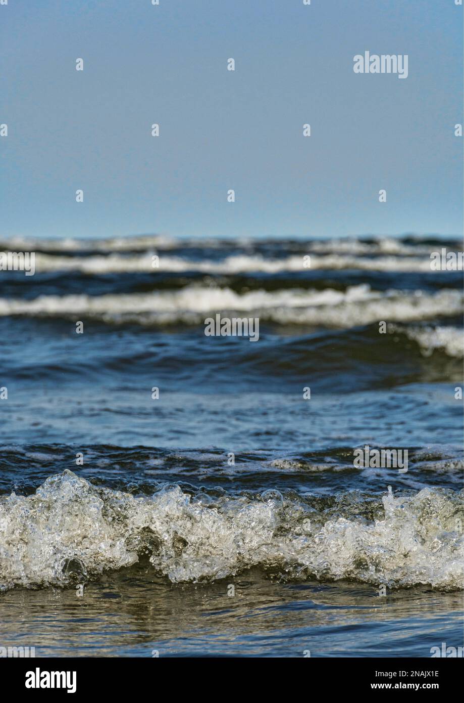Sea waves with a cloudless sky in the background, vertical format Stock ...