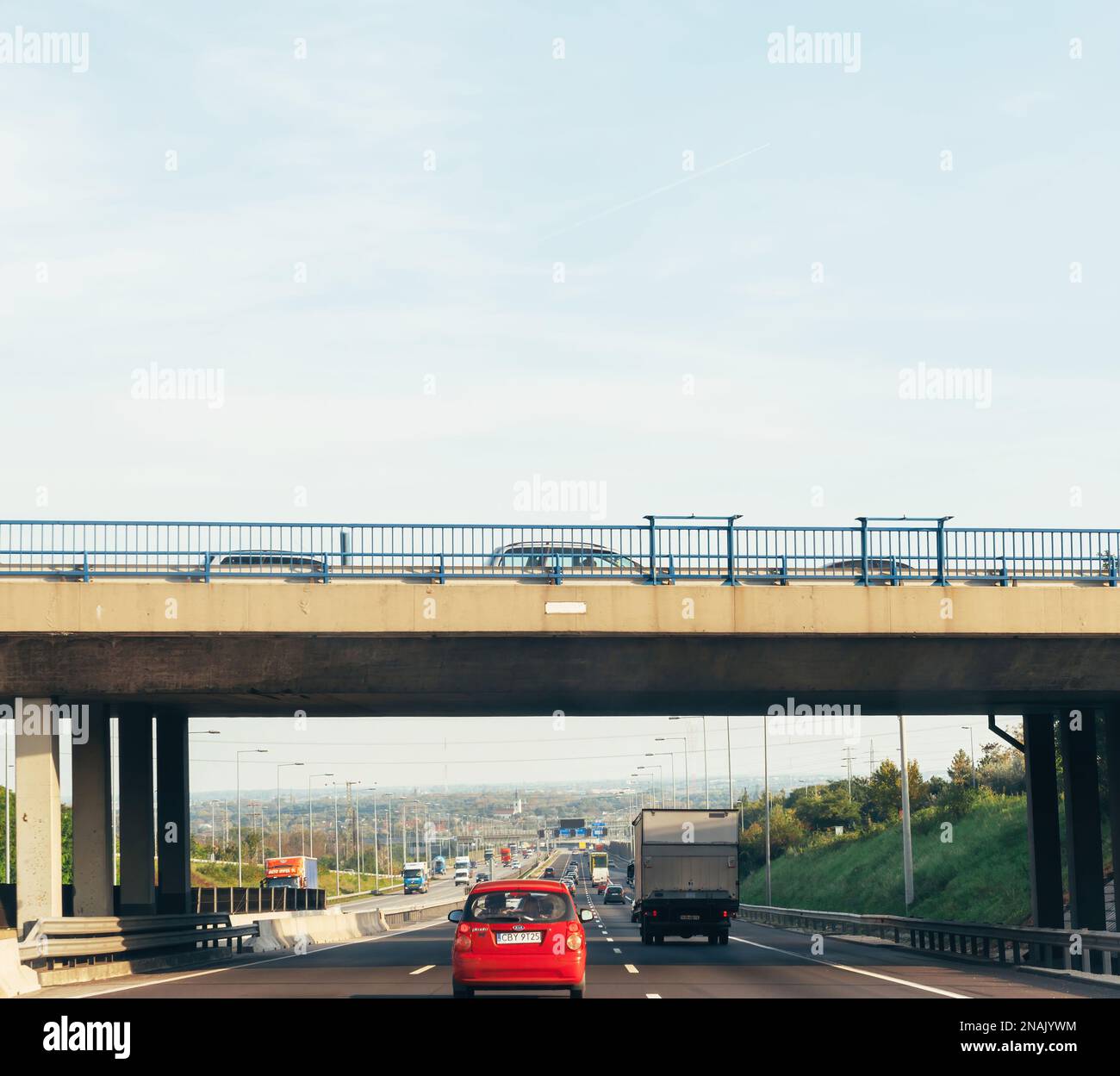Hungary - Sep 30, 2014: Red car driving fast under bridge with multiple ...