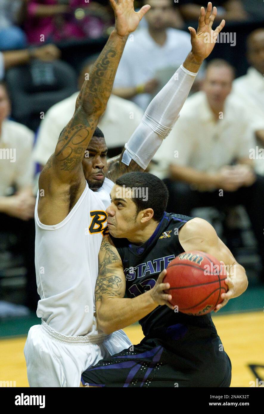 Long Beach State forward Eugene Phelps, left, blocks the path of Kansas ...