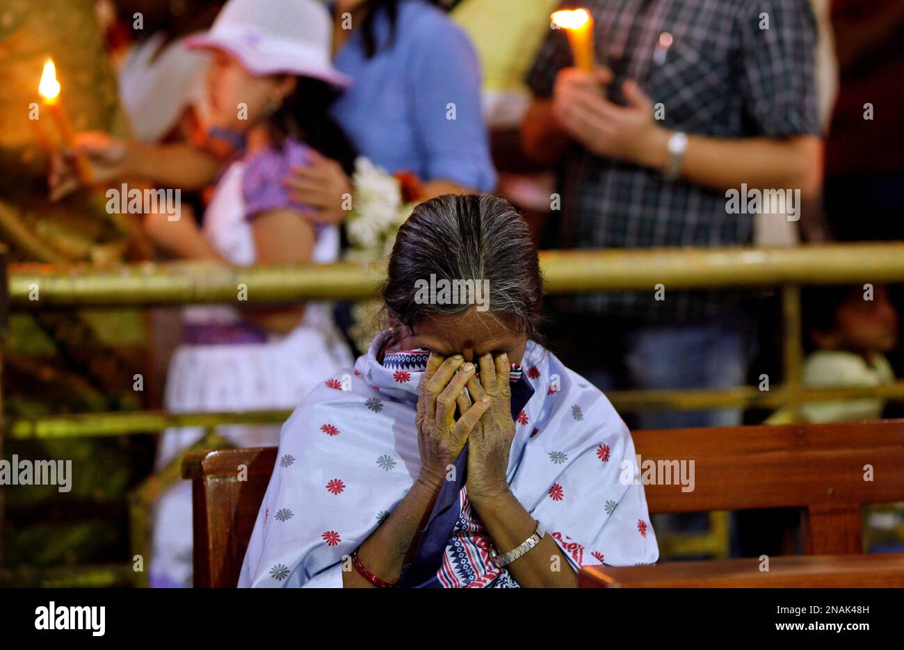 A devotee breaks down as she prays at the Infant Jesus Shrine on ...