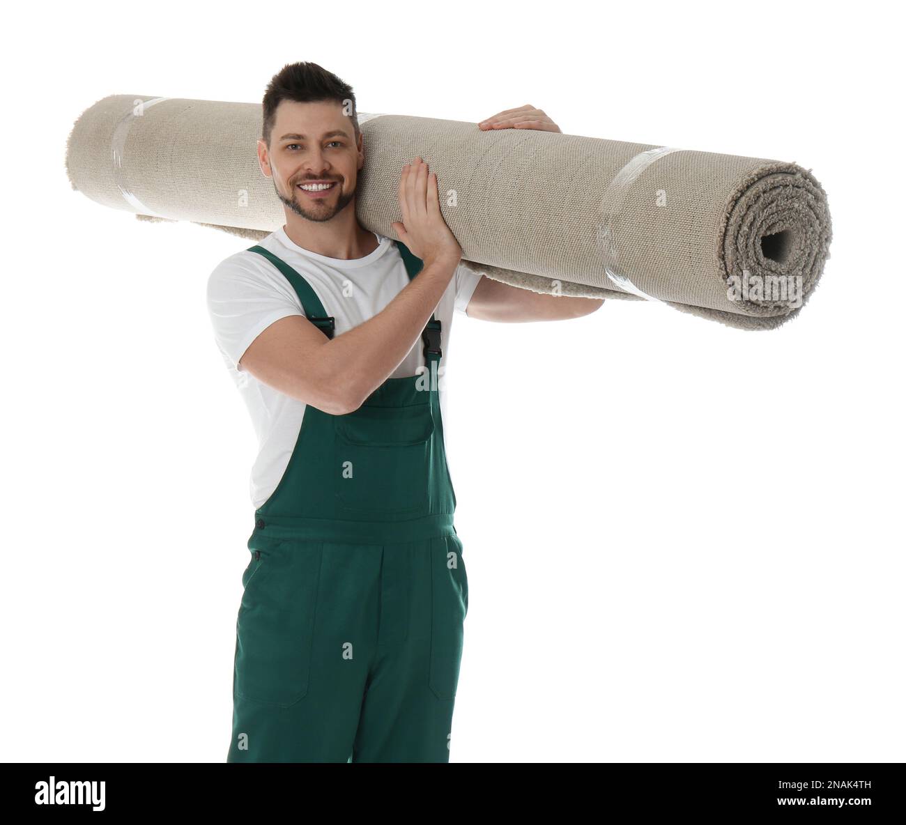 Male worker with rolled carpet on white background Stock Photo - Alamy