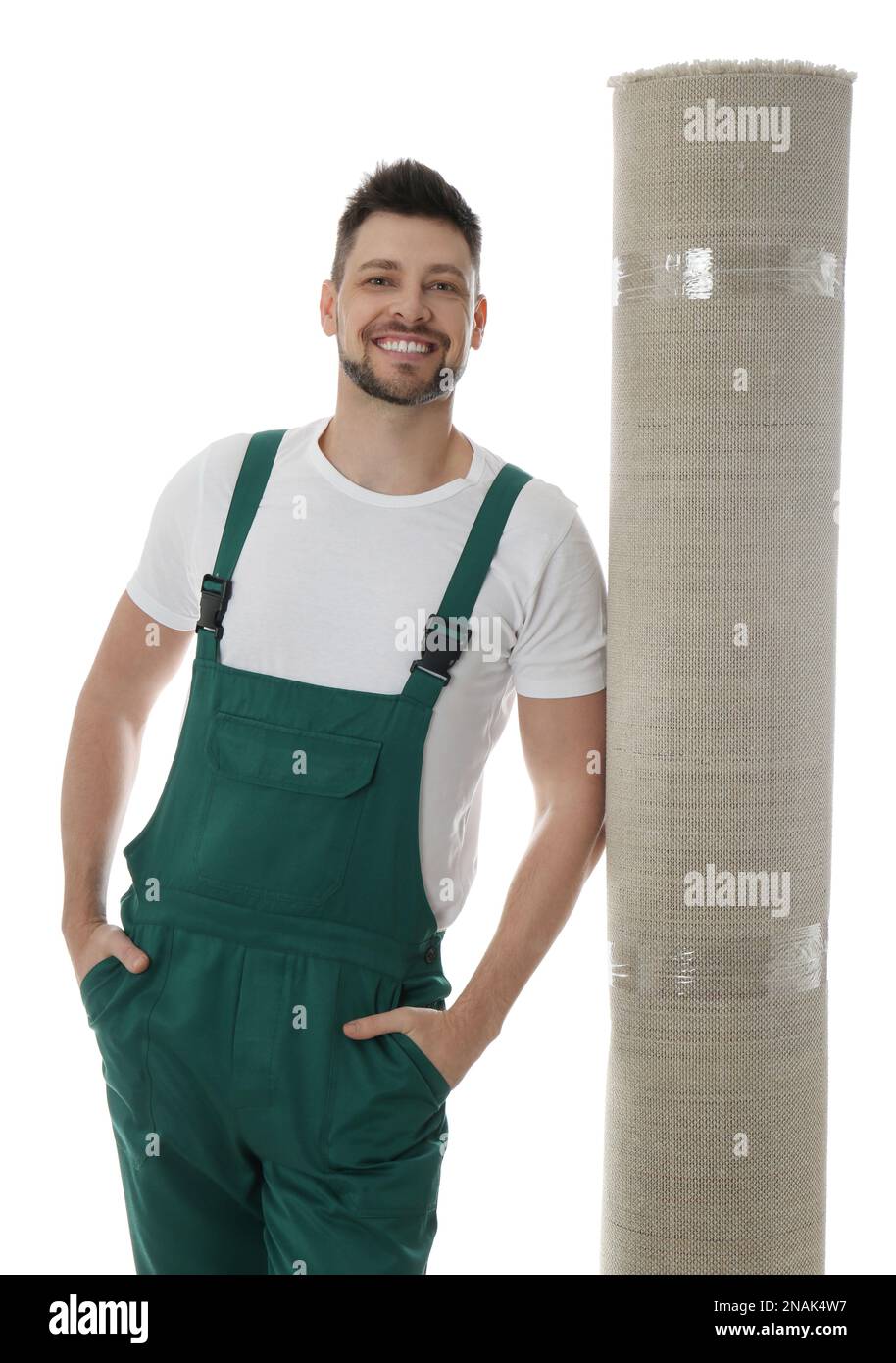 Male worker with rolled carpet on white background Stock Photo - Alamy