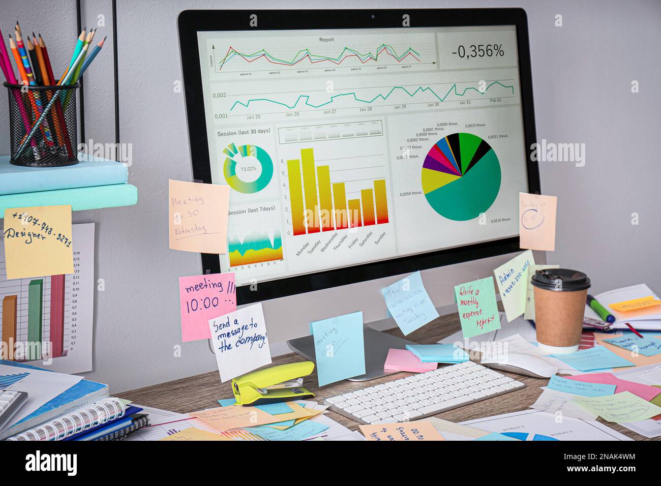 Computer, notes and office stationery in mess on desk, space for text ...