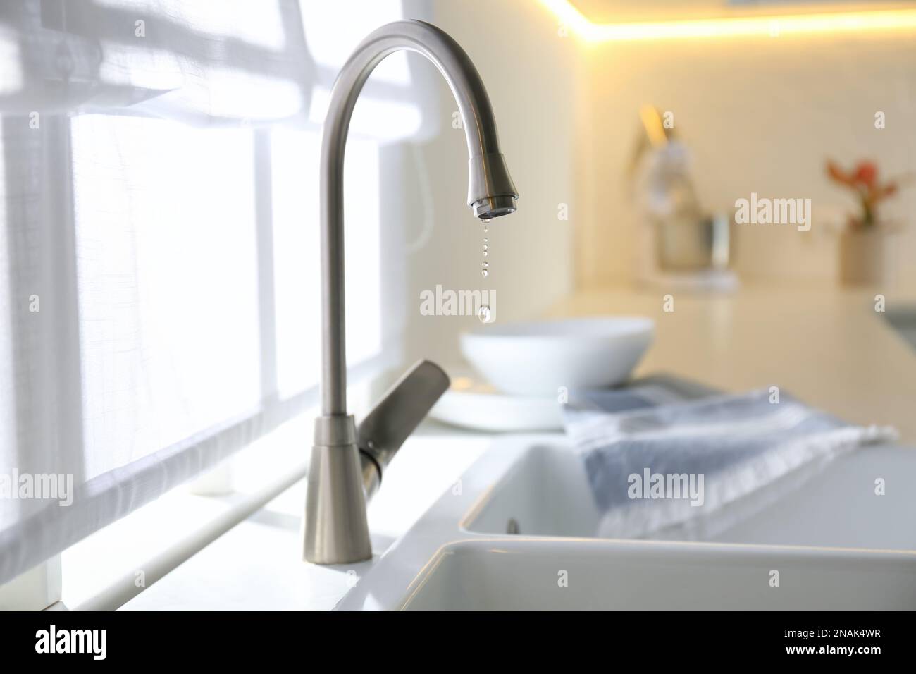Water drops falling down from tap in kitchen Stock Photo - Alamy