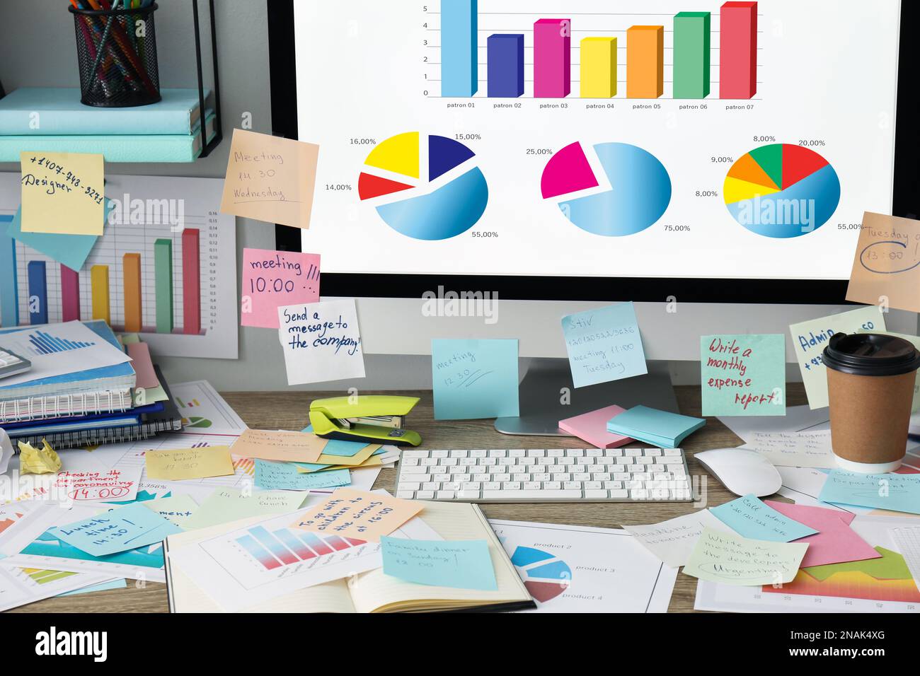 Computer, notes and office stationery in mess on desk, space for text ...