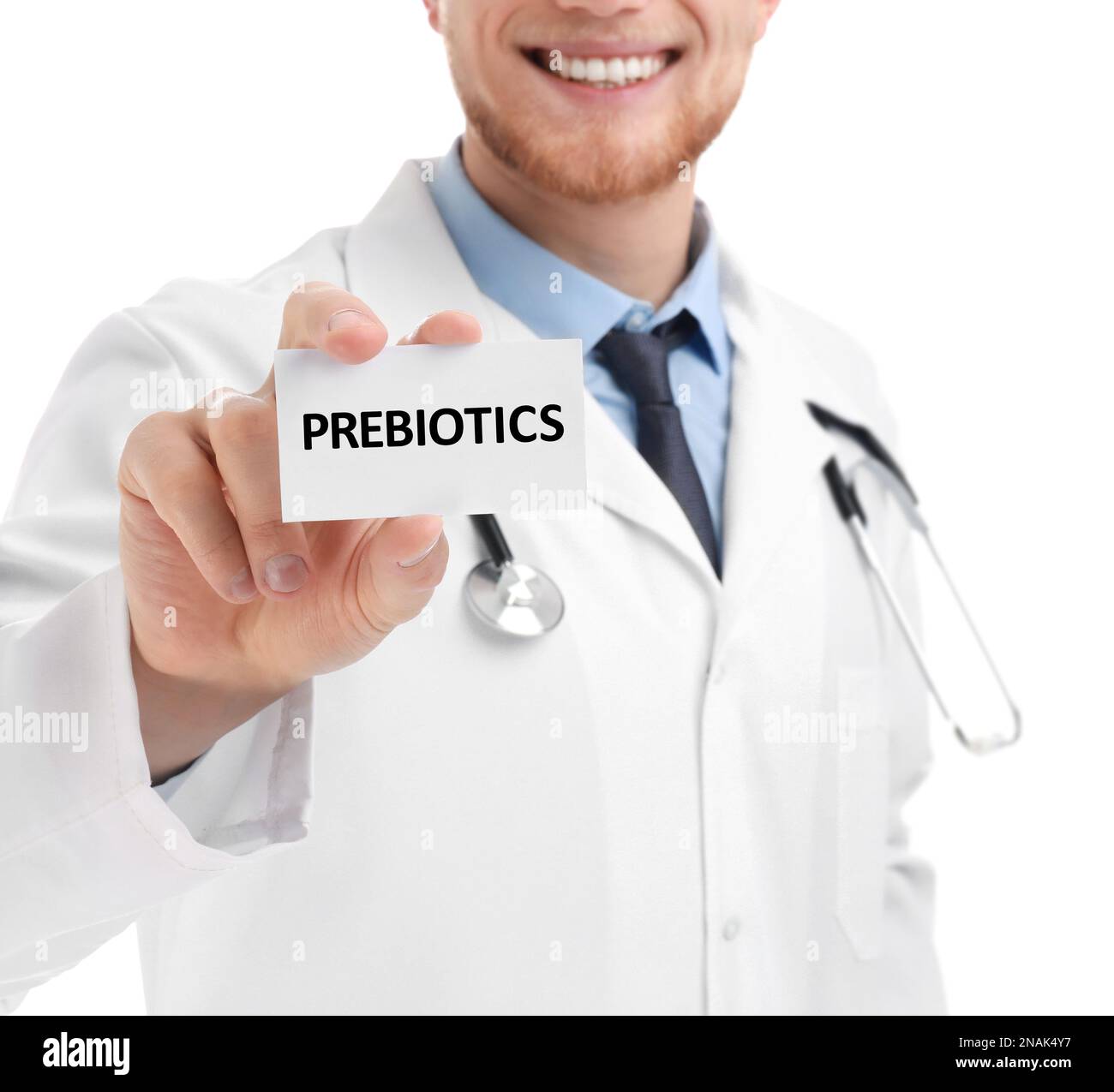Doctor holding card with word PREBIOTICS on white background, closeup ...