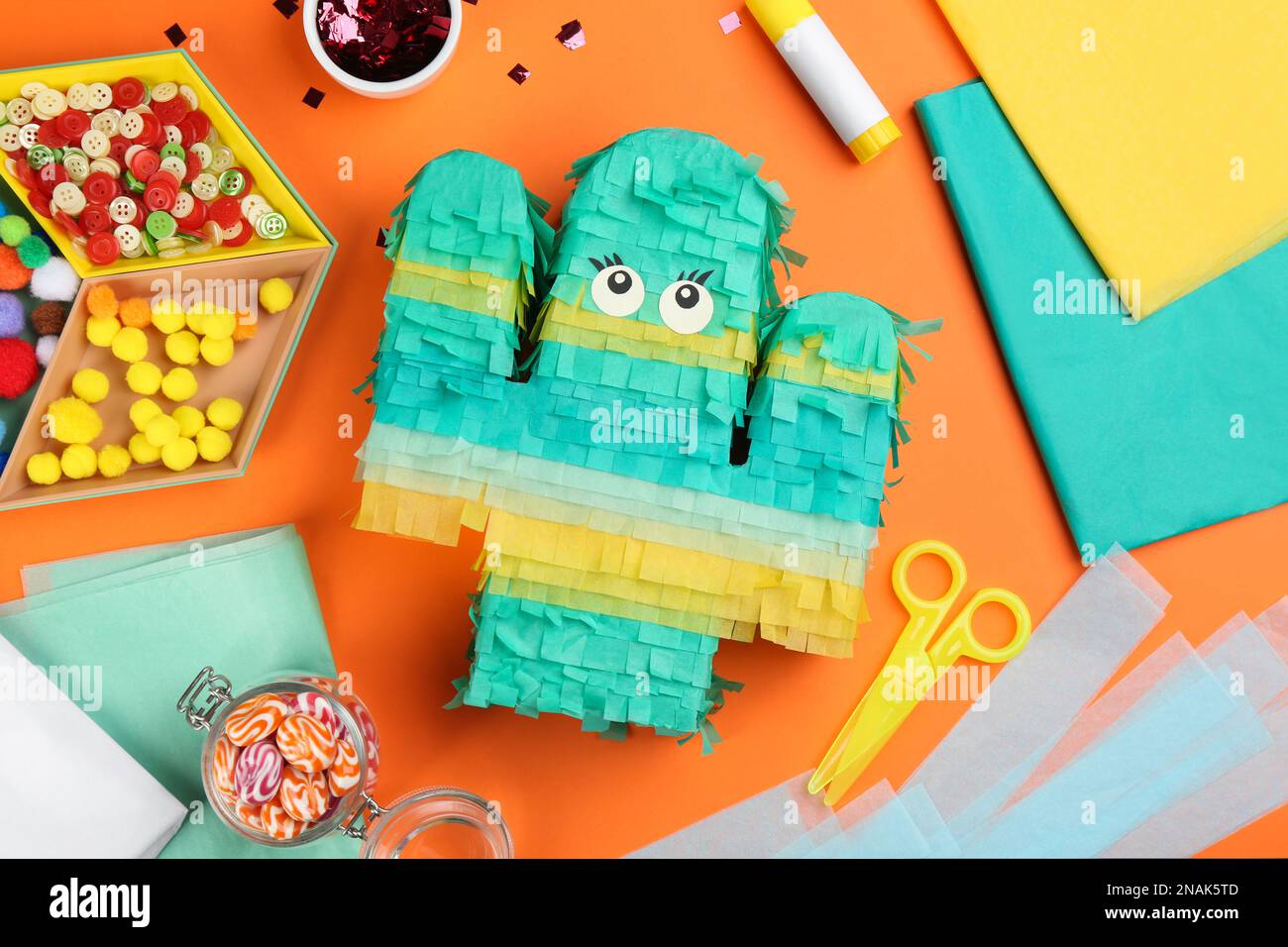 Flat lay composition with cardboard cactus on orange background. Pinata ...