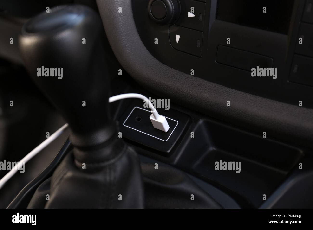 White USB charging cable plugged in inside modern car Stock Photo - Alamy