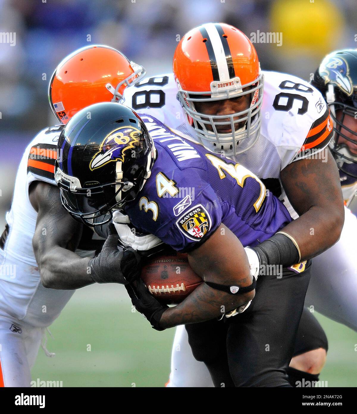 Baltimore Ravens running back Ricky Williams (34) tries to break free ...