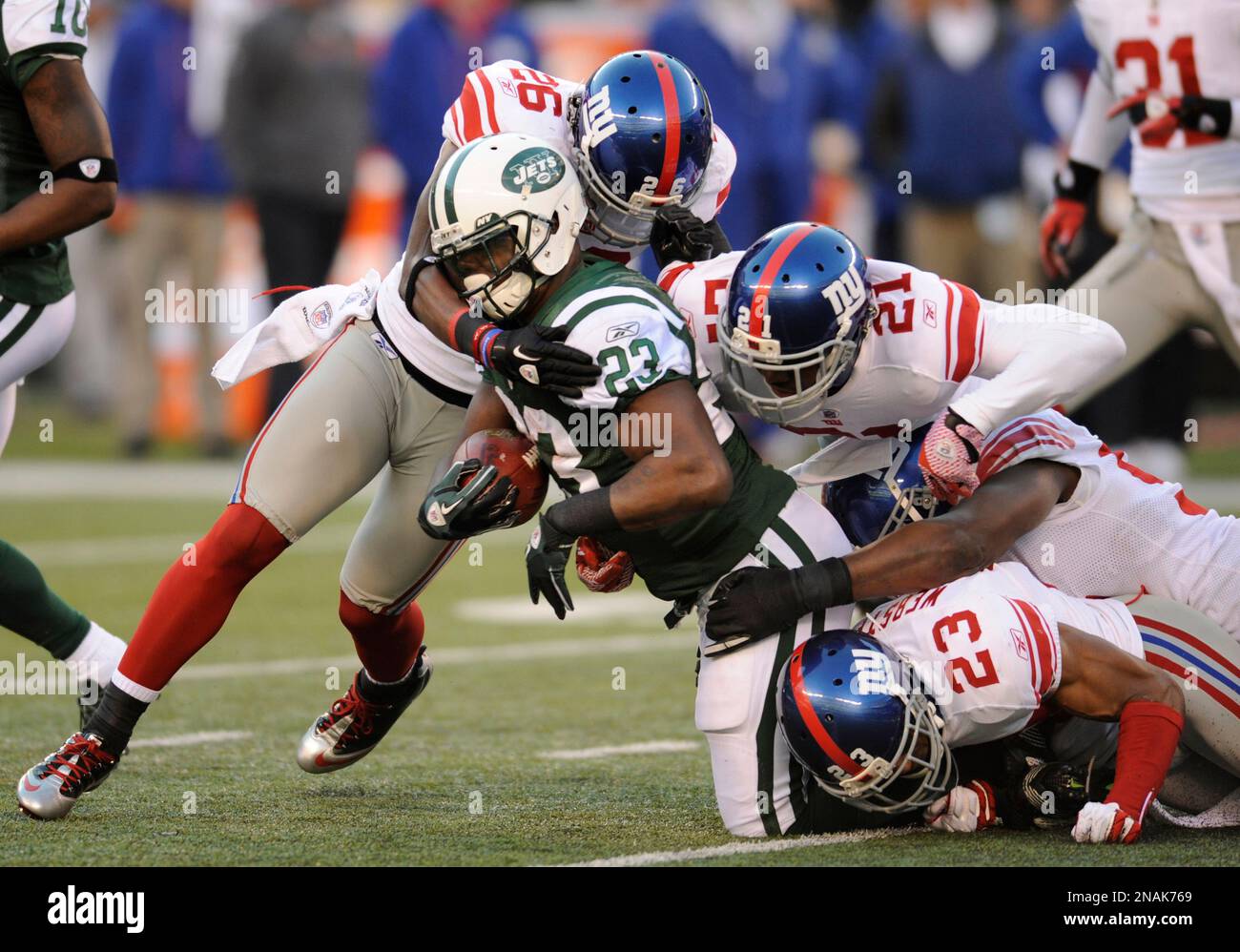 New York Jets' Shonn Greene, center, is brought down by New York Giants ...