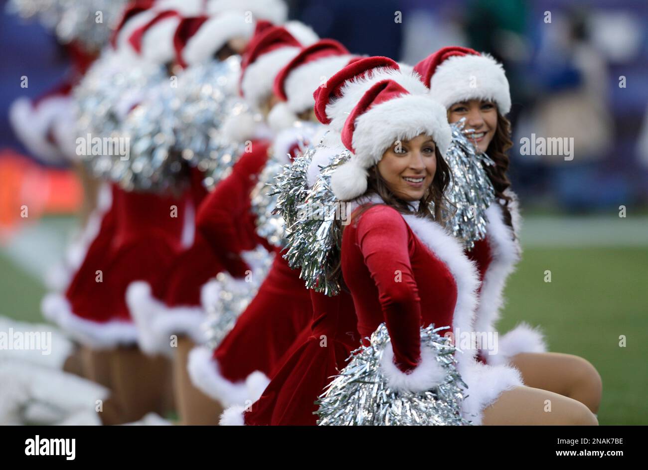 New England Patriots cheerleaders dressed in Santa suits perform during ...