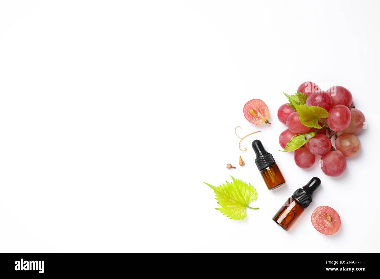 Composition with bottles of natural grape seed oil on white background ...
