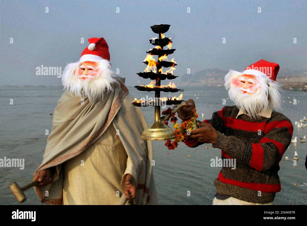 Indian devotees dressed as Santa Claus pray at Sangam, confluence of ...