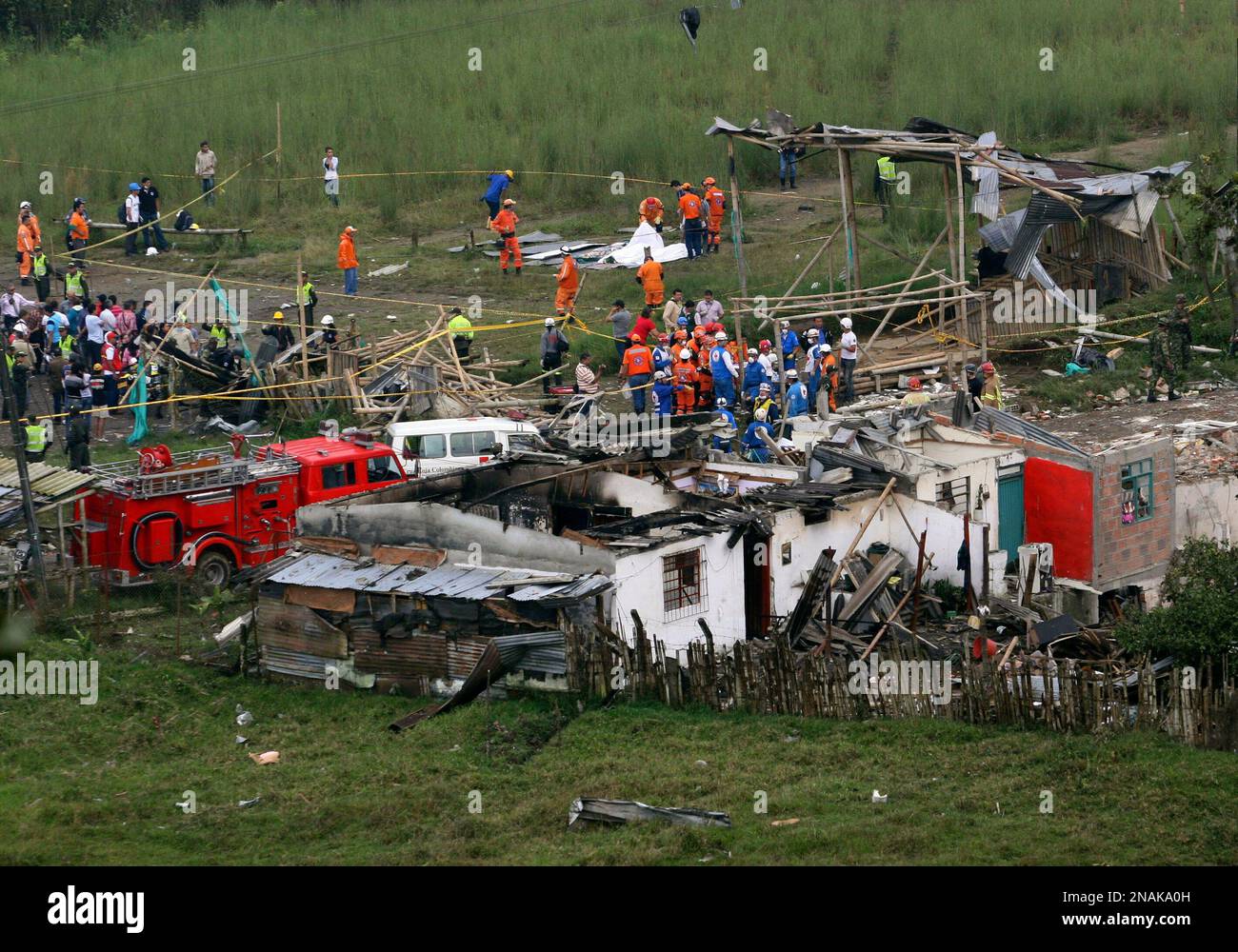 People and rescue workers gather at the site of a pipeline explosion in ...
