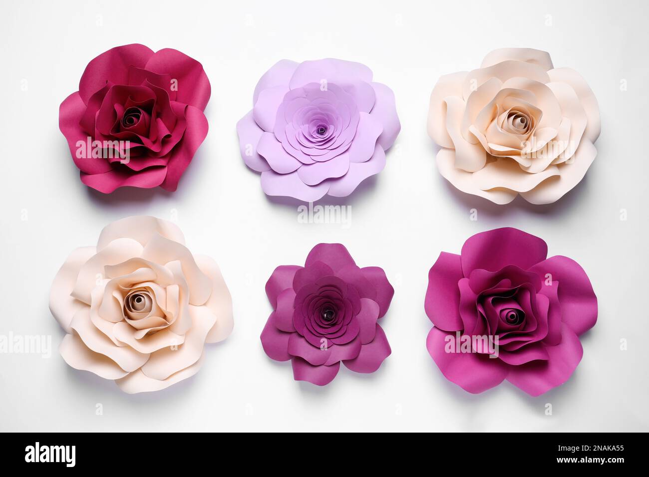 Different beautiful flowers made of paper on white background, top view ...
