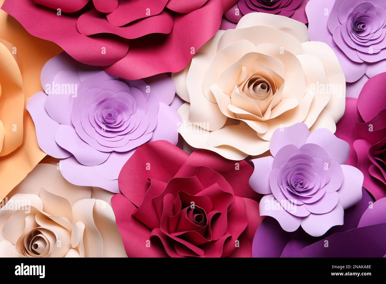 Different beautiful flowers made of paper as background, above view ...