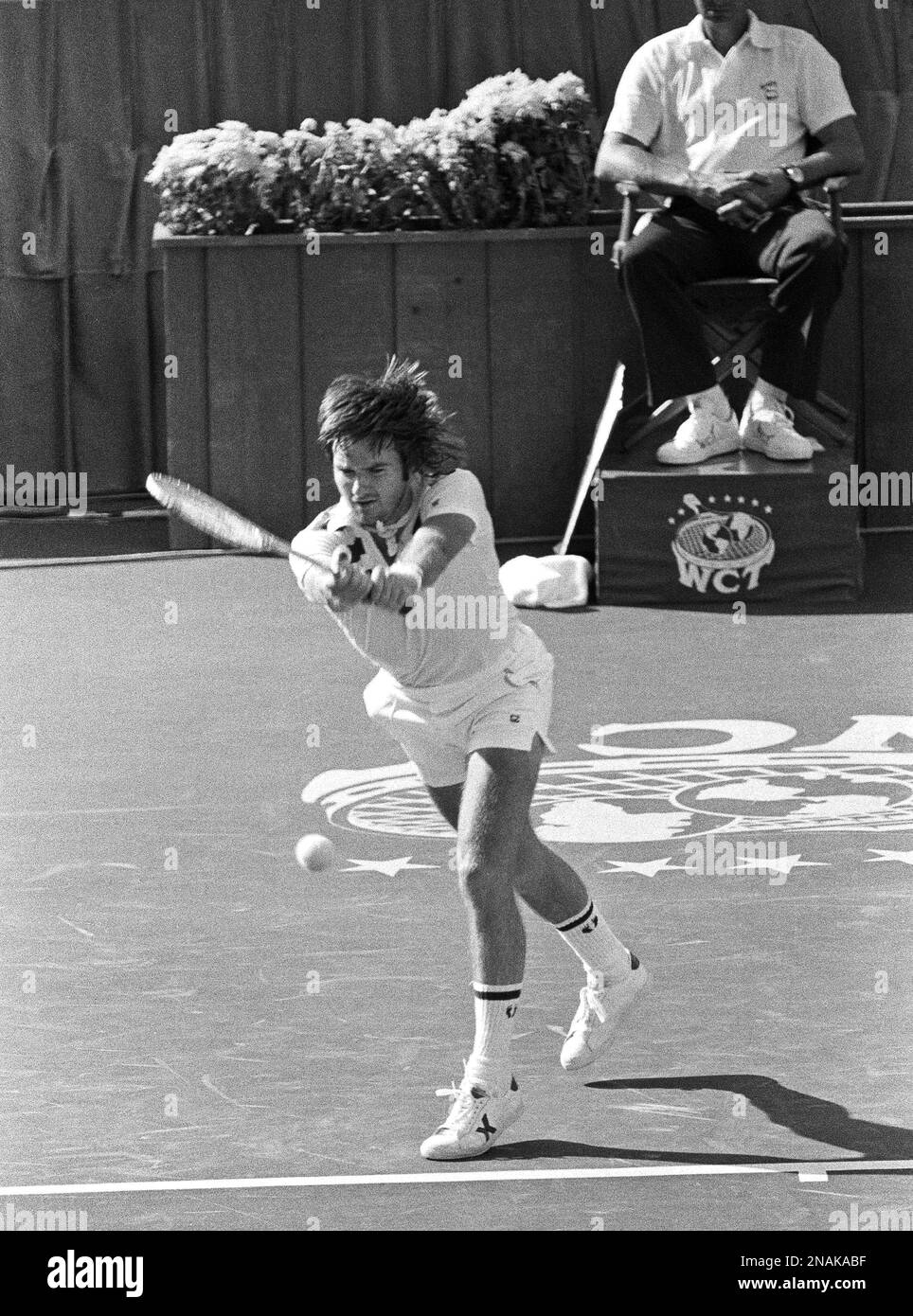 Jimmy Connors takes a hefty, baseball bat-like-swing as he returns one ...