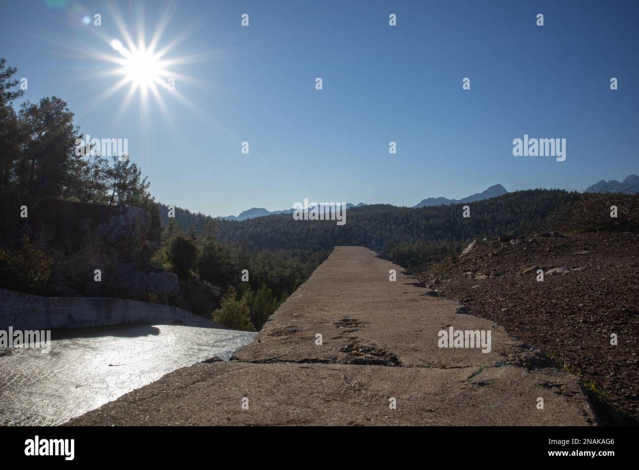 A concrete wall stretching into the distance in the rays of the sun ...