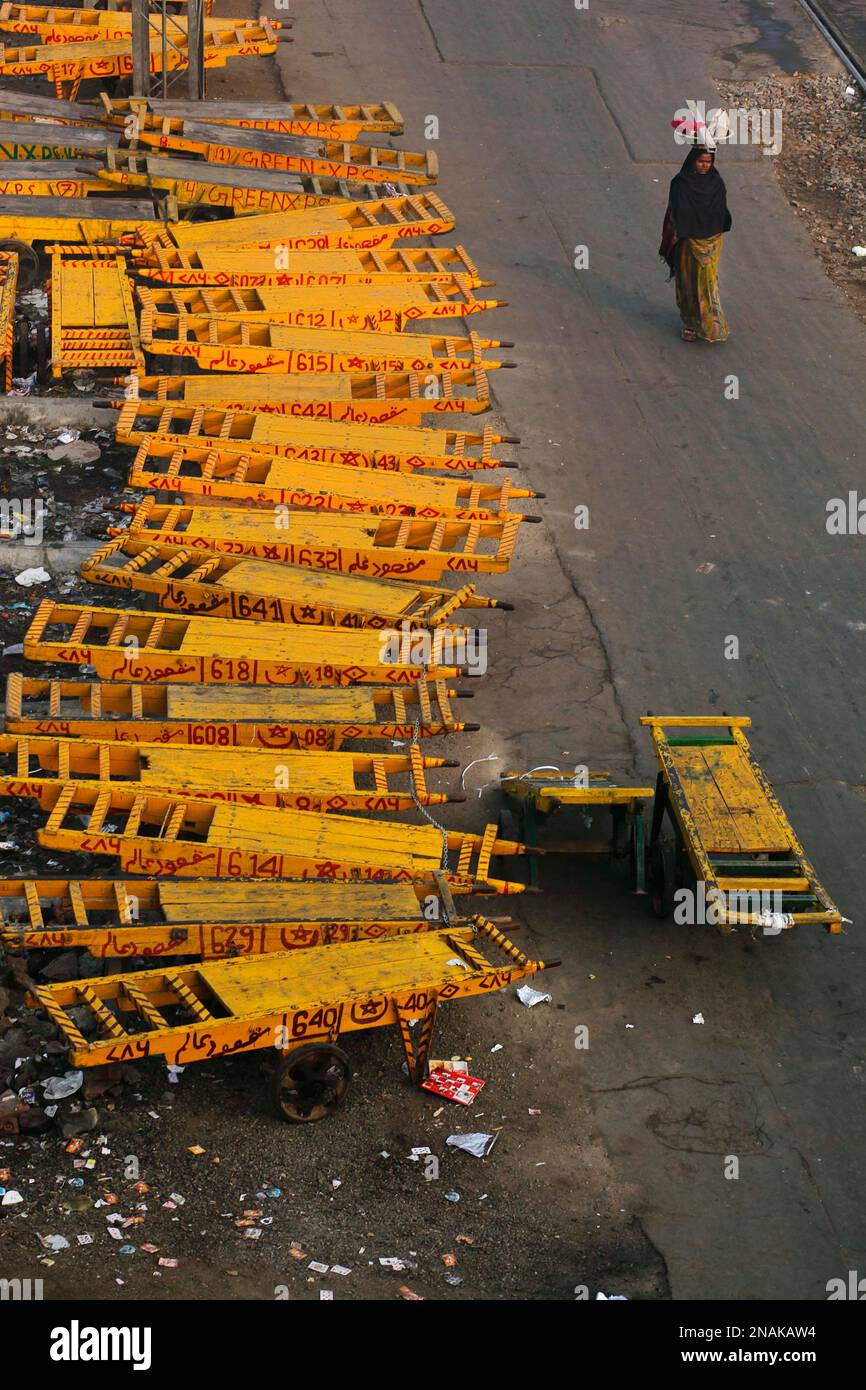 An Indian woman goes for her daily work as she walks past empty ...