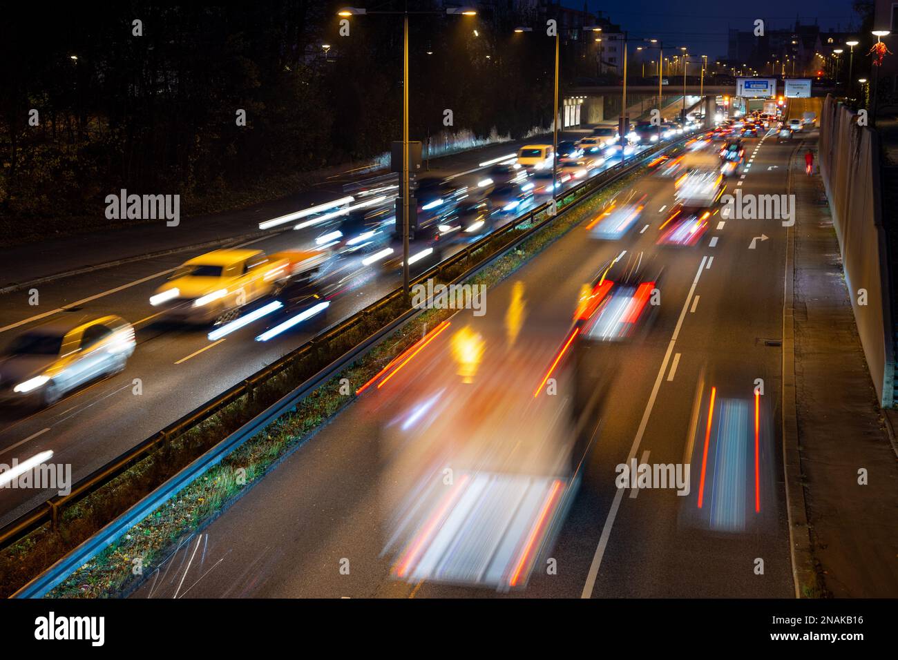 Light trails and streaks from fast moving traffic along a highway in ...