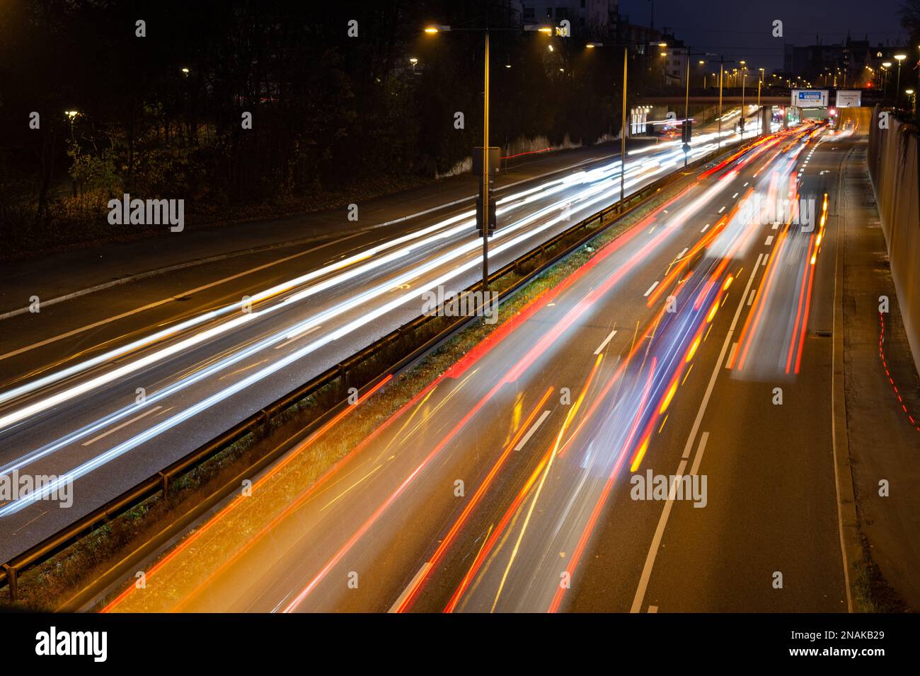 Light trails and streaks from fast moving traffic along a highway in ...