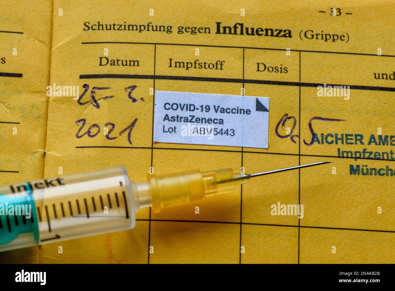 Syringe and vaccination certificate with entry for vaccination with ...