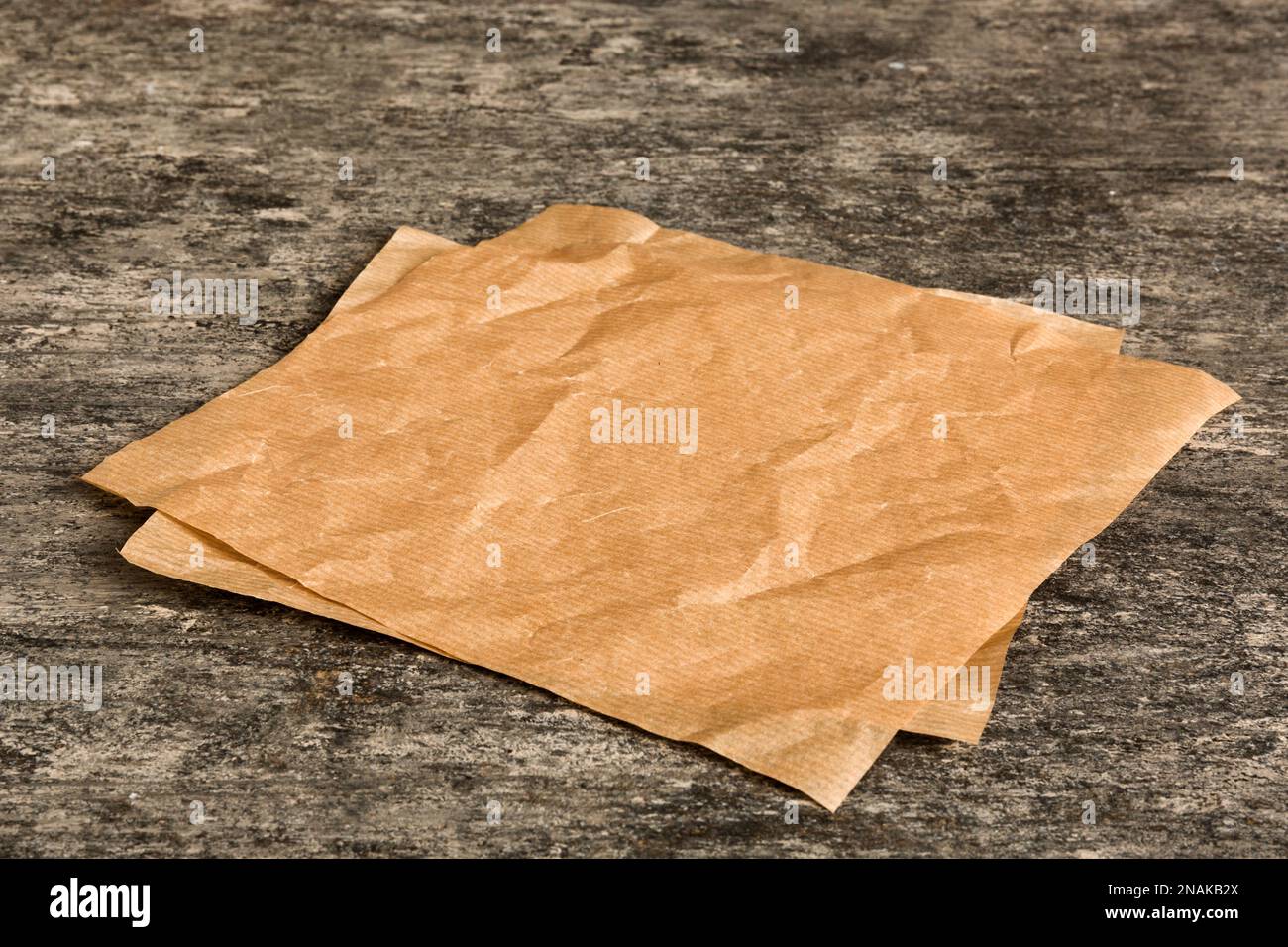 top view with baking parchment empty on table background. Folded cloth ...