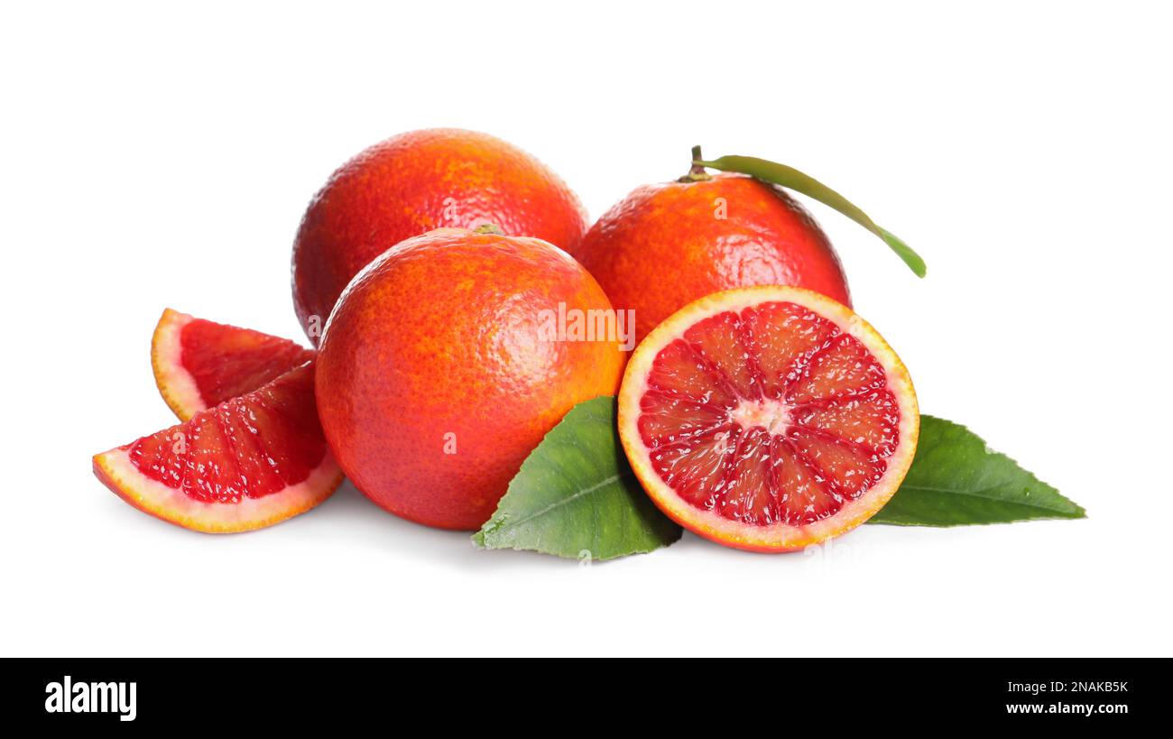 Whole and cut red oranges with green leaves on white background Stock ...