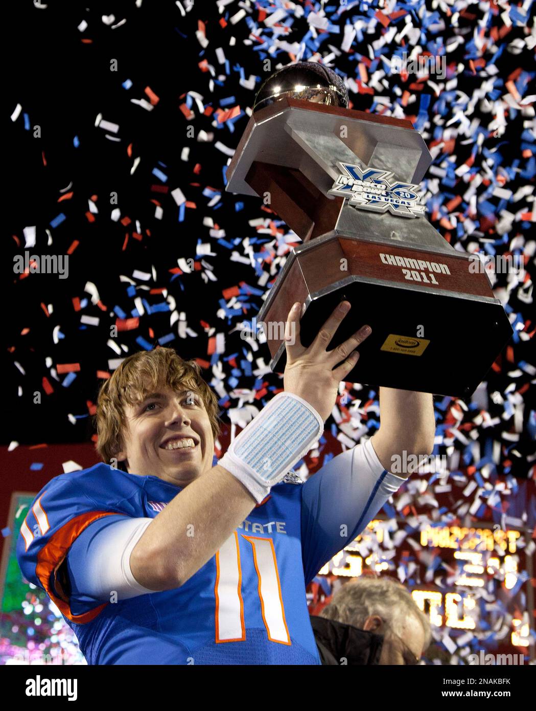 Boise State quarterback Kellen Moore (11) holds up the trophy after the ...