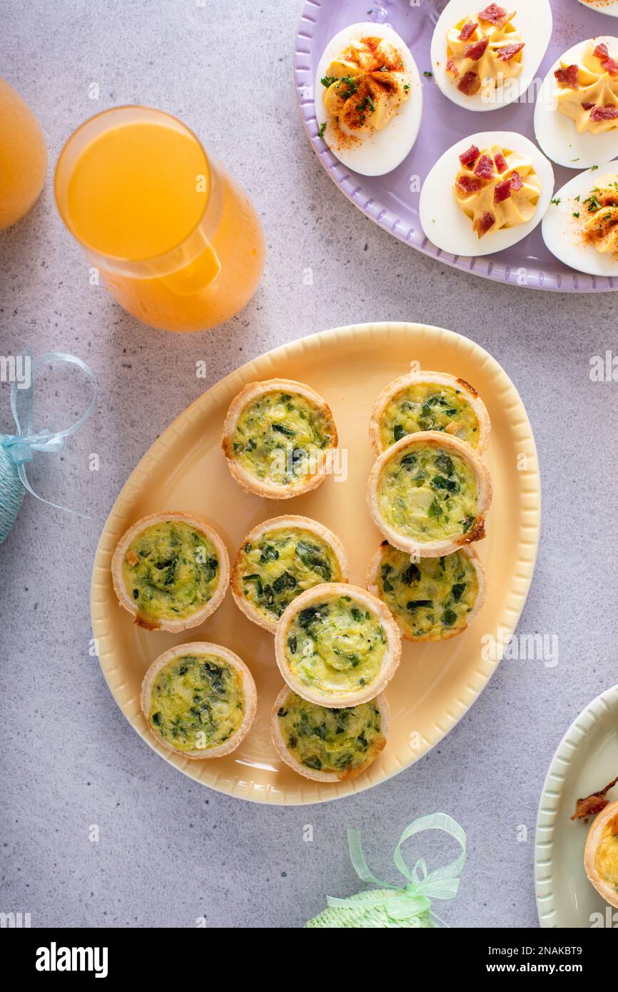 Mini quiches with spinach for Easter brunch, quiche florentine top view ...