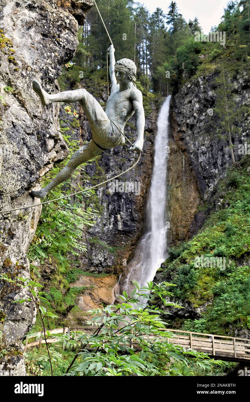 Tervela Waterfall and the sculpture of the mountain climber Stock Photo ...