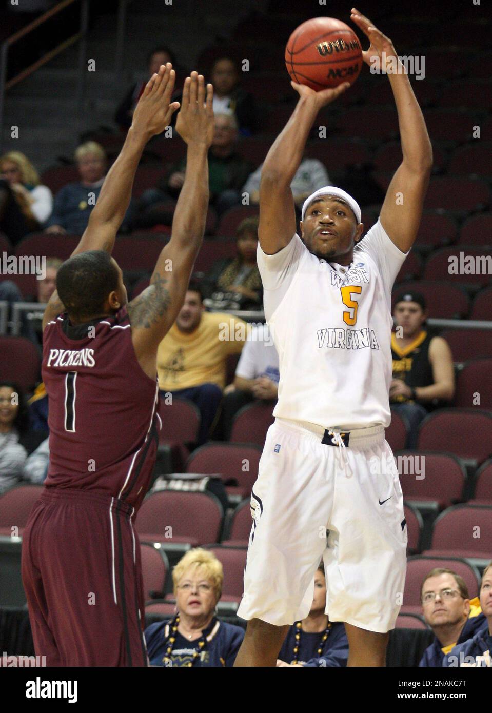 West Virginia's Kevin Jones, right, shoots over Missouri State's Kevin ...