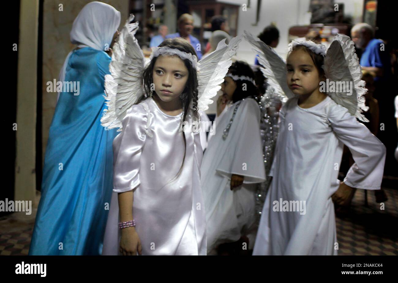 Children dressed as angels prepare at the bacstage before performing in ...
