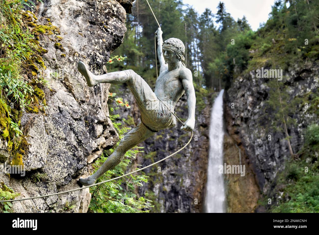 Tervela Waterfall and the sculpture of the mountain climber Stock Photo ...