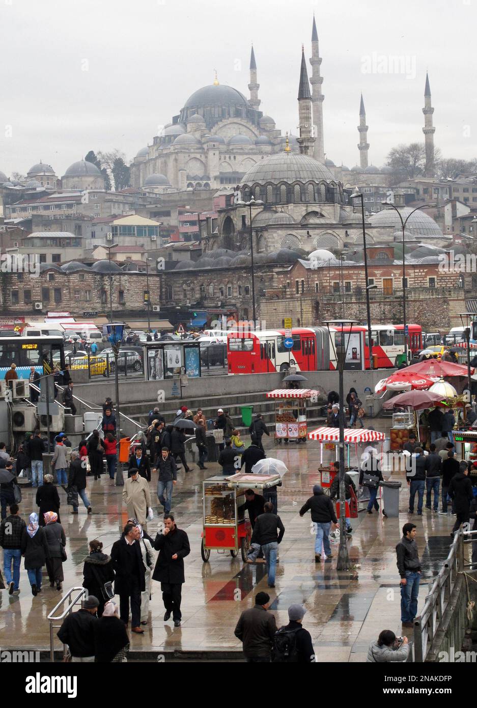 Pedestrians walk in Eminonu district during a rainy day in Istanbul ...