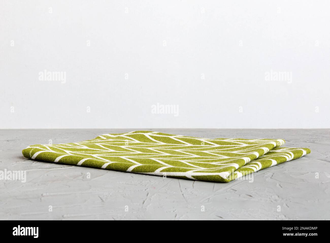 top view with green kitchen napkin isolated on table background. Folded ...